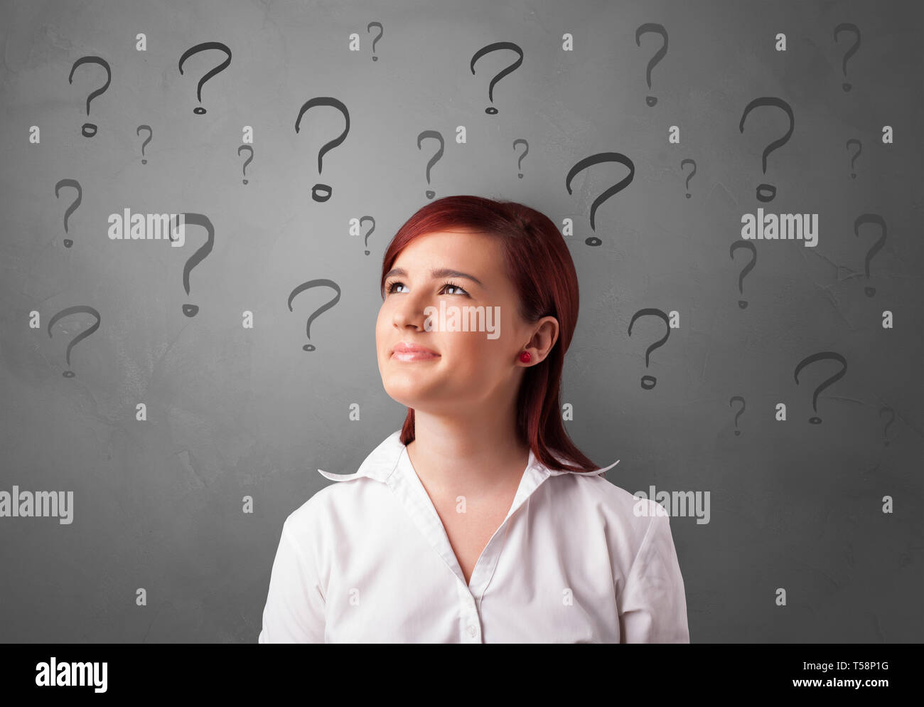Person with question marks around face Stock Photo - Alamy