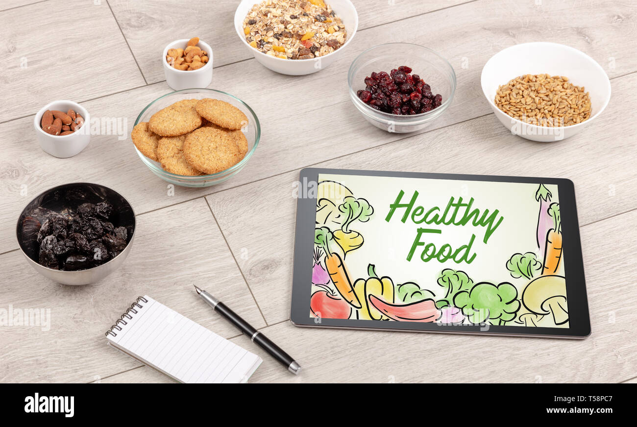 Healthy food composition with tablet Stock Photo - Alamy