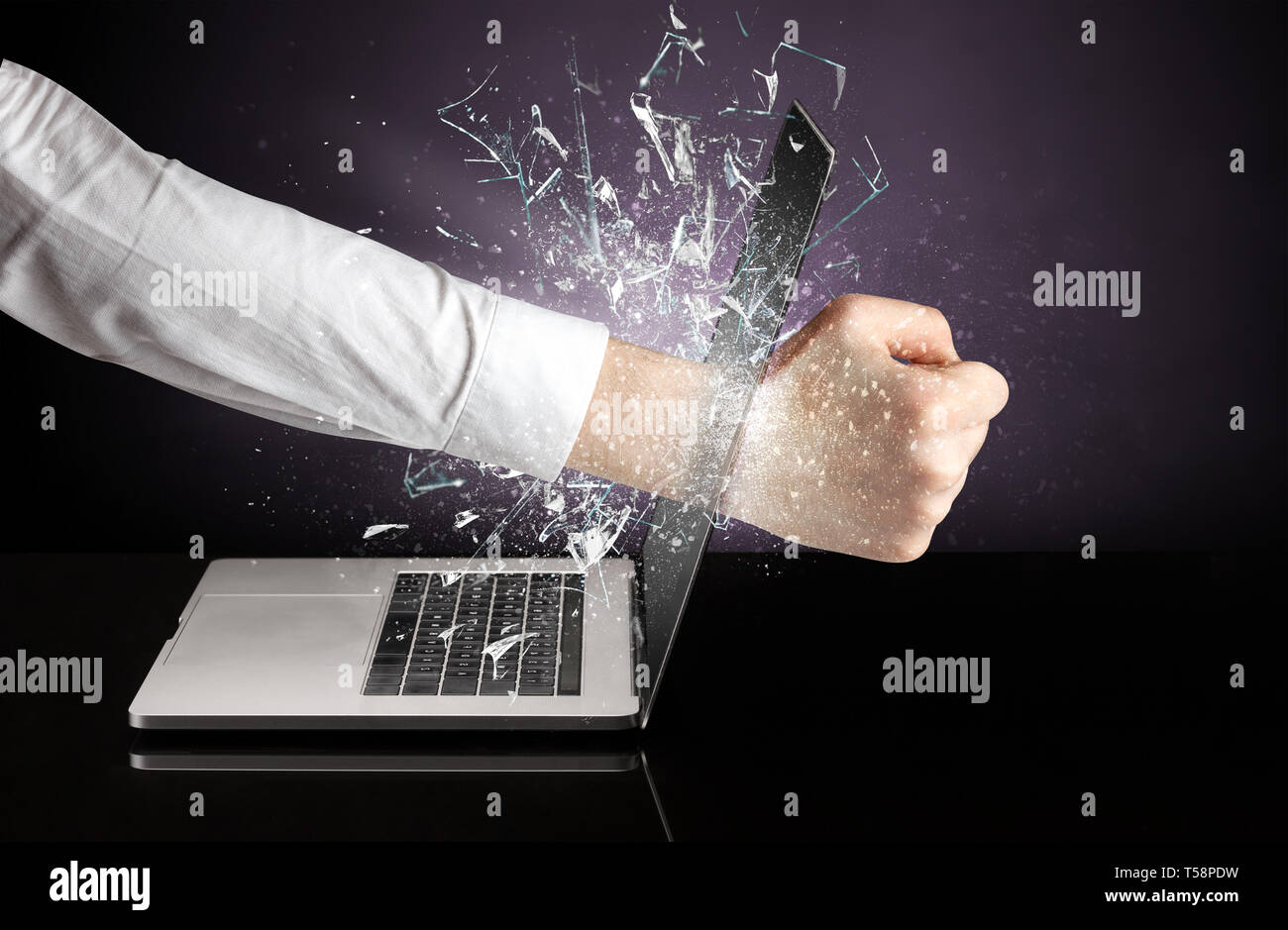 Hand hitting strongly laptop screen glass Stock Photo - Alamy