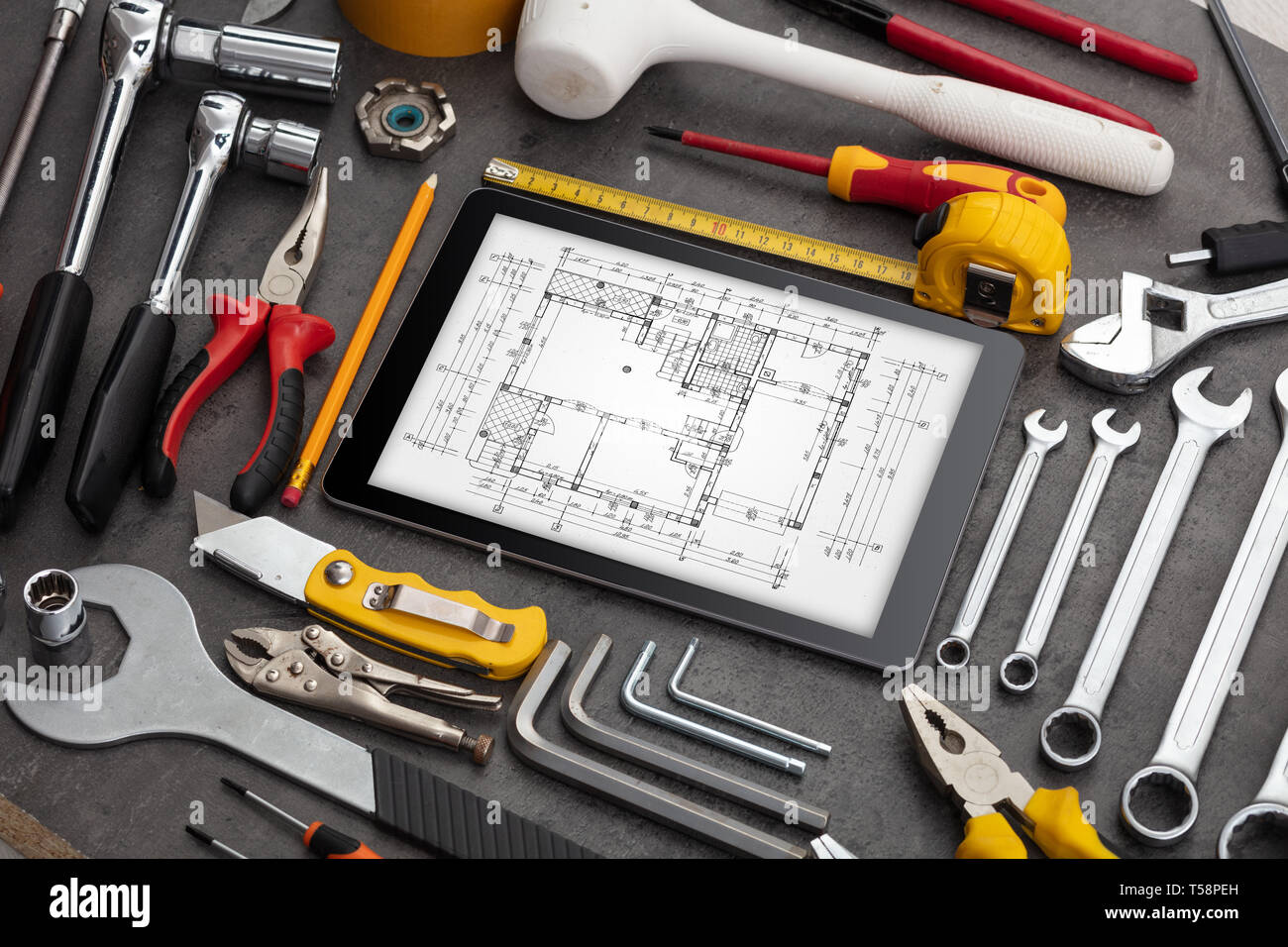 Tablet with construction tools and blueprint concept Stock Photo - Alamy