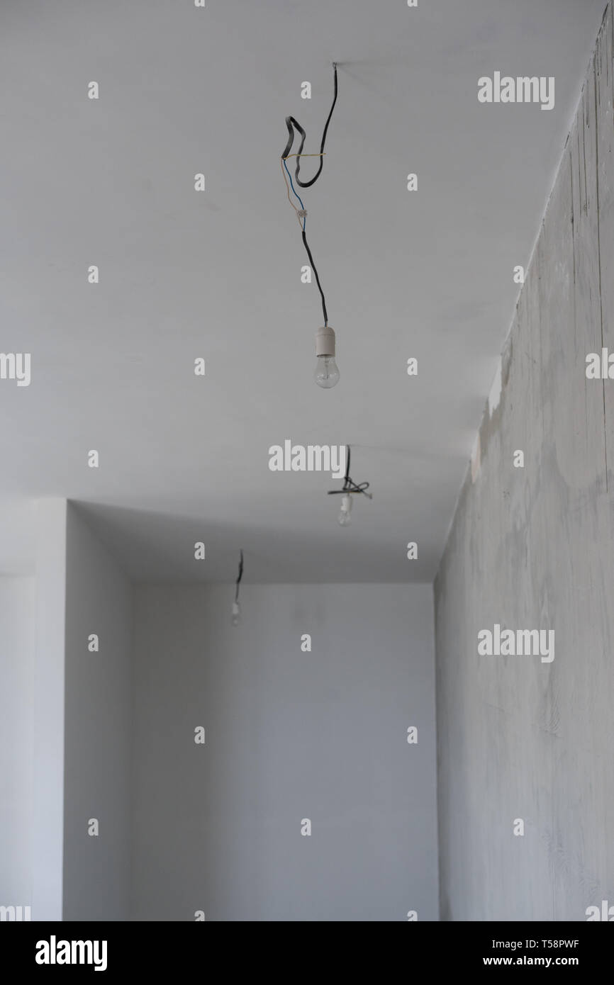 light bulbs hanging on the wire in the white room Stock Photo - Alamy