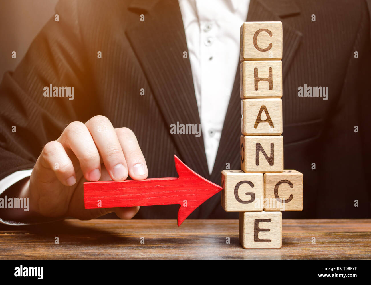 Businessman points to wooden blocks with the word Change to Chance ...