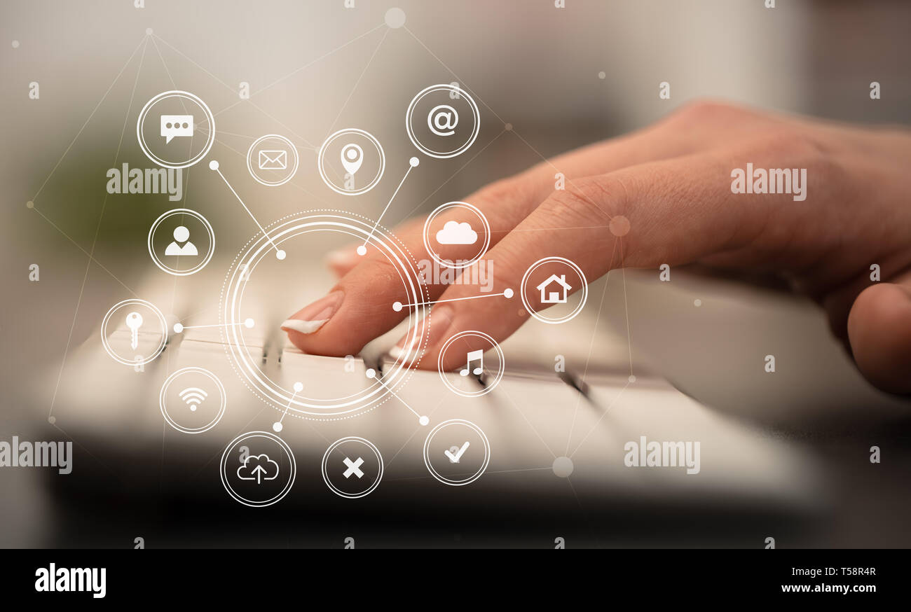 Business woman hand typing on keyboard with application icons around ...