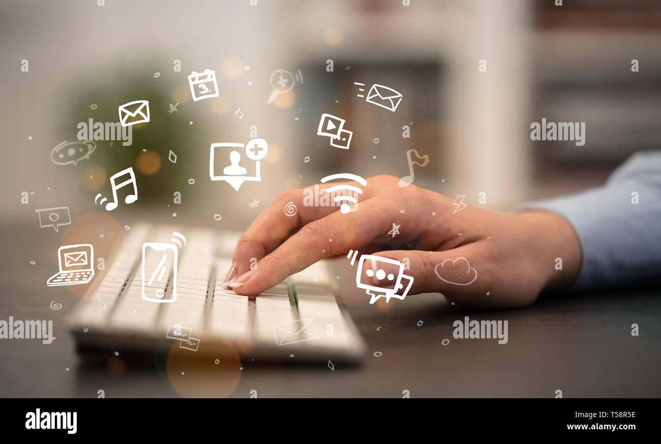 Business woman hand typing on keyboard with drawn application icons ...