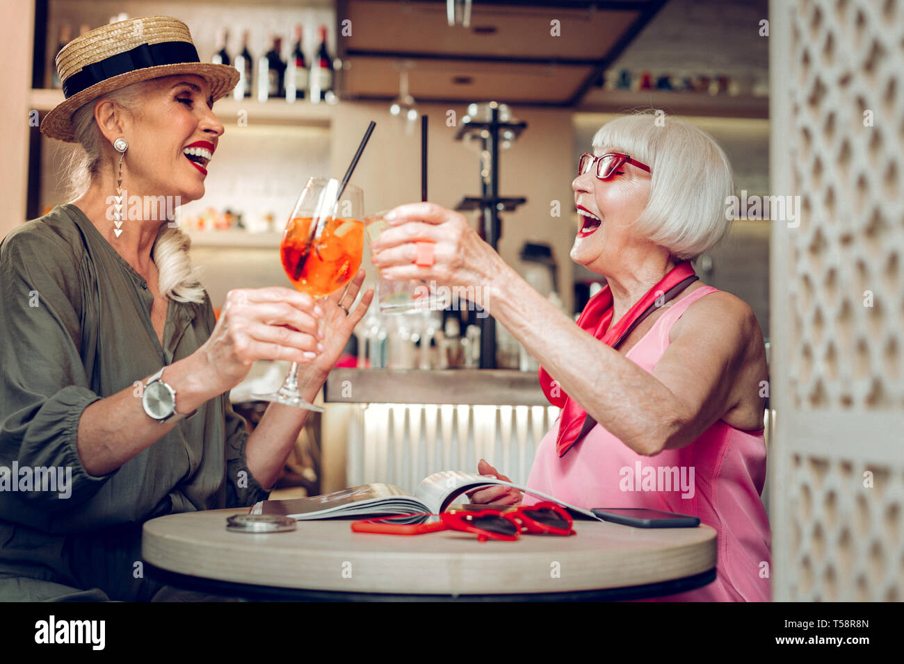 Joyful happy women cheering with their cocktails Stock Photo - Alamy