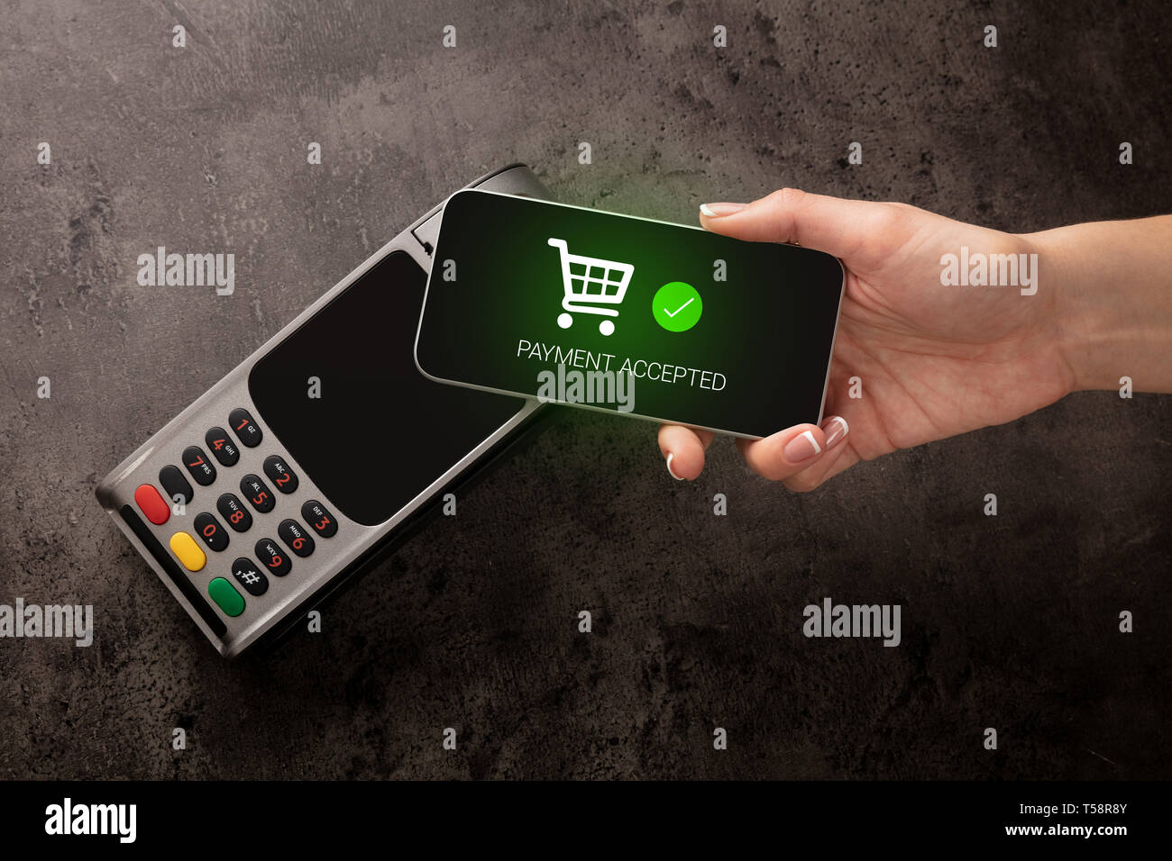 Mobile payment accepted on terminal Stock Photo - Alamy