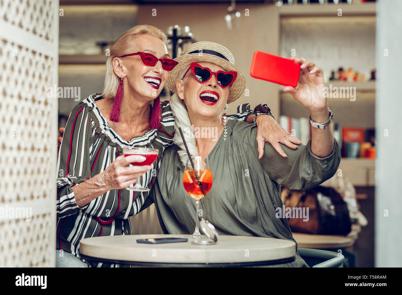 Two old friends hugging each other hi-res stock photography and images ...