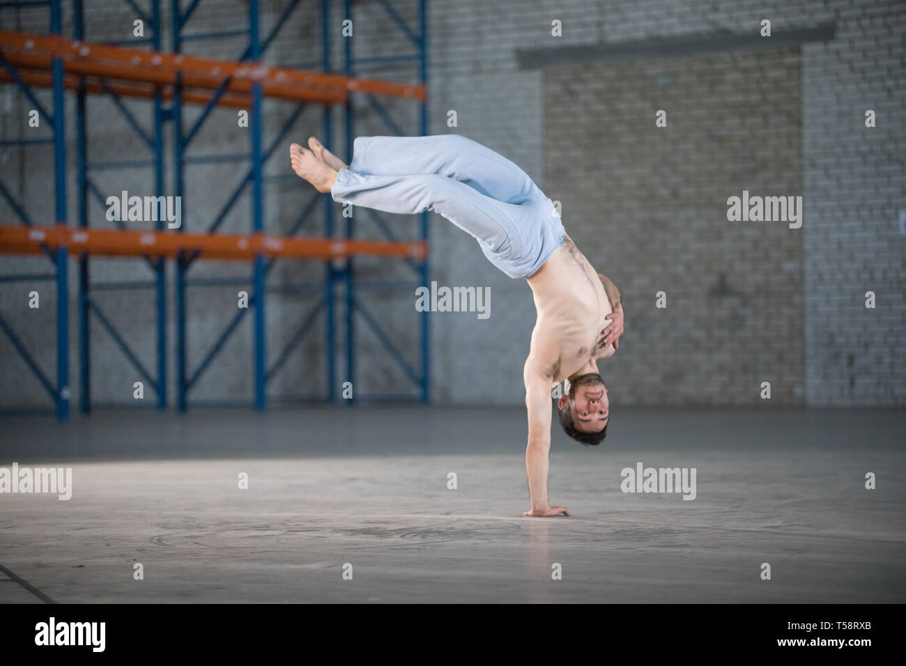 An athletic man on capoeira training. Standing on one hand Stock Photo ...
