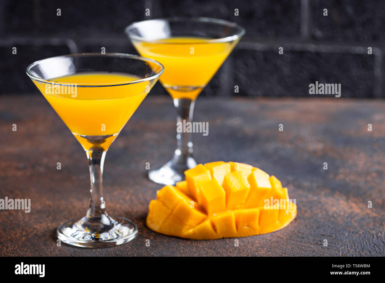 Tropical cocktail with mango on dark background Stock Photo - Alamy