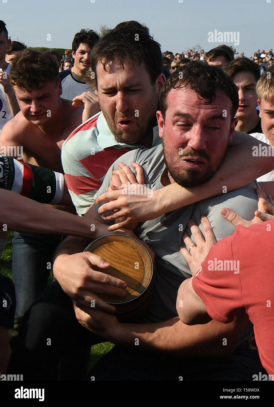 A man grips the 'bottle', an old field barrel holding about a gallon of ...