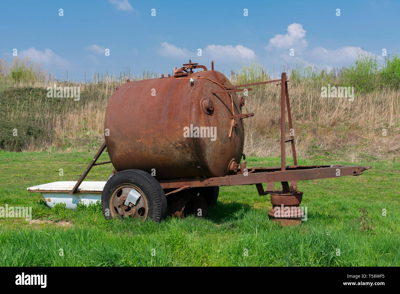 Rusty drinking water tank for cows with a bathtub as drinking trough in ...