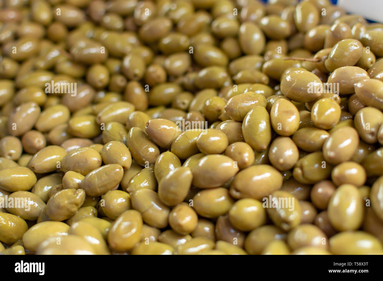 Traditional greek food ingredient, green olives in box on farmer market ...