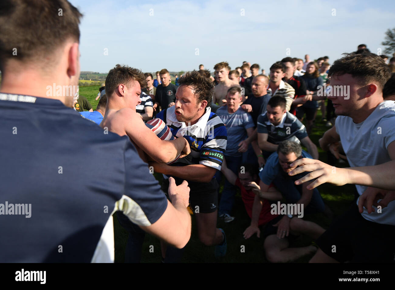 People grapple over the 'bottle', an old field barrel holding about a ...