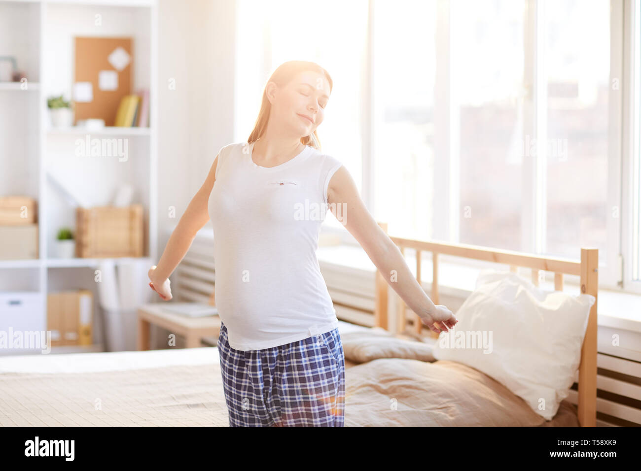 happy young family expecting child looking up Stock Photo - Alamy