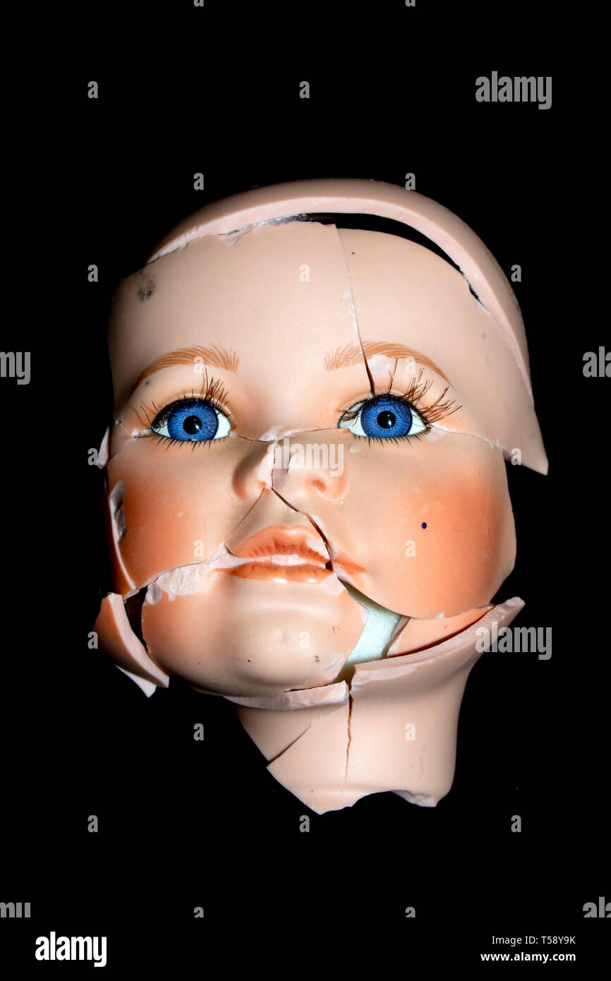 Broken Doll Body Parts Faces on Black Background Stock Photo - Alamy