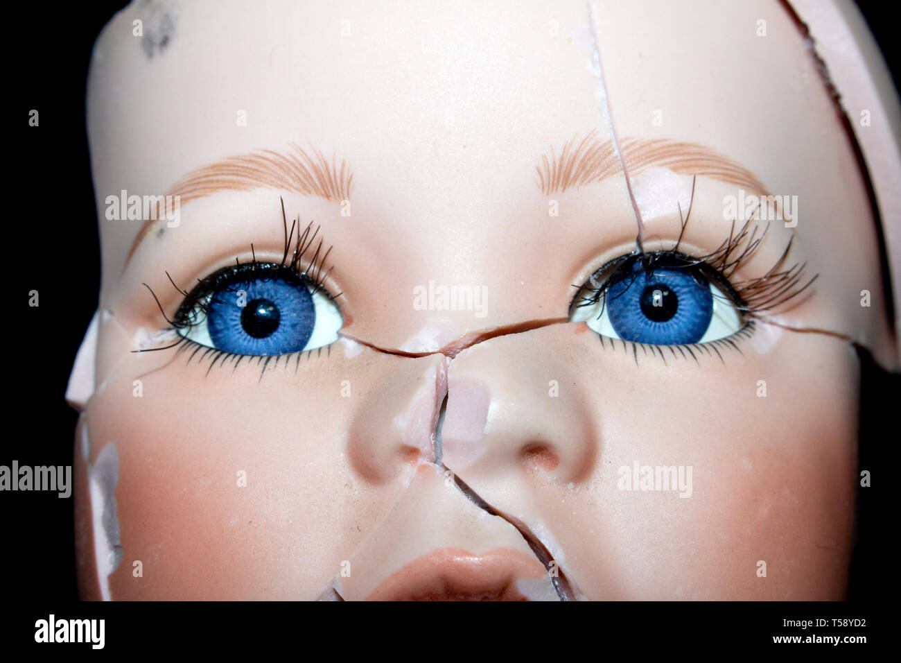 Broken Doll Body Parts Faces on Black Background Stock Photo - Alamy