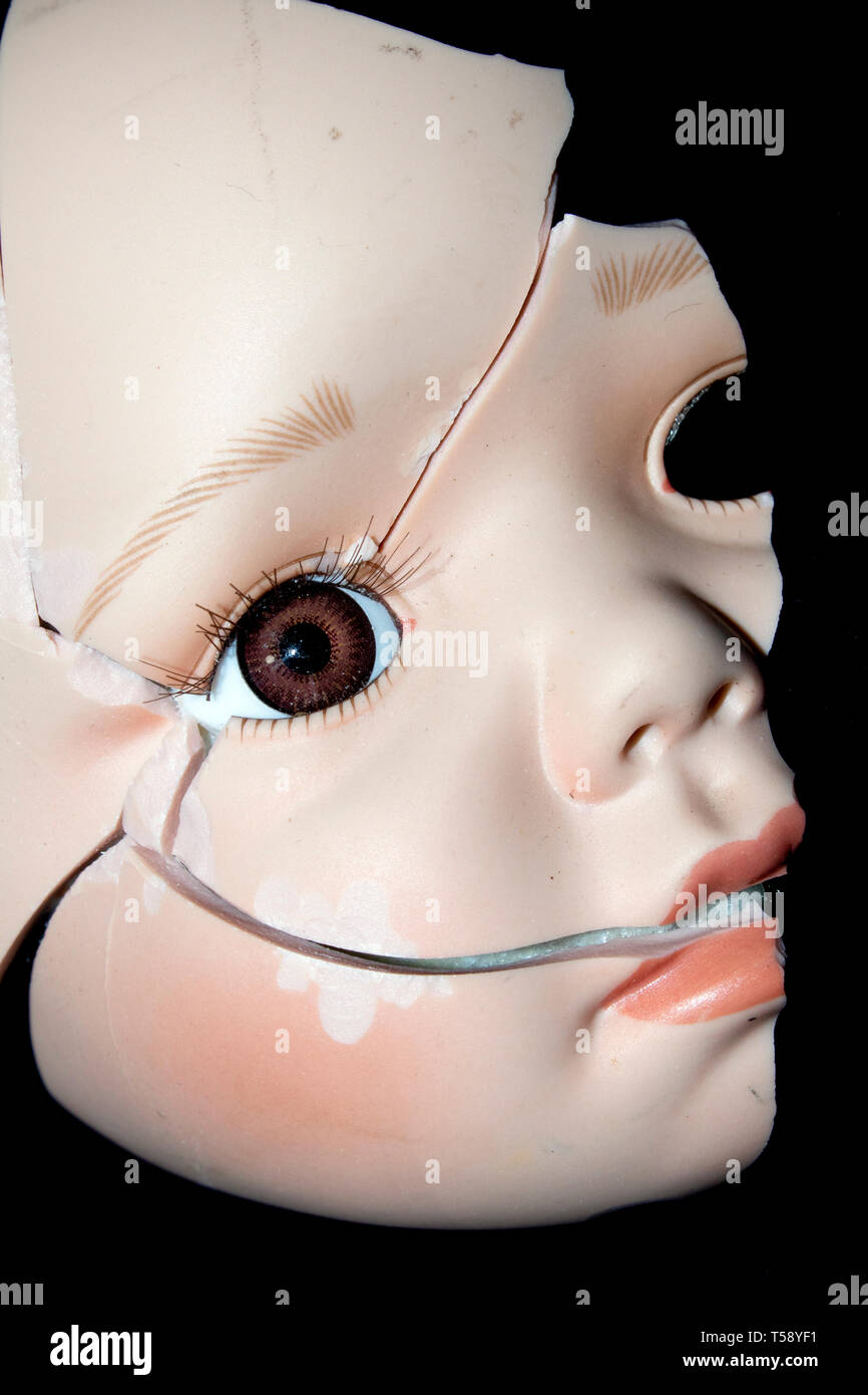 Broken Doll Body Parts Faces on Black Background Stock Photo - Alamy