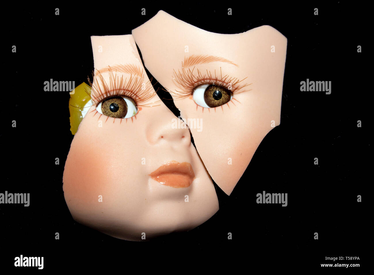 Broken Doll Body Parts Faces on Black Background Stock Photo - Alamy