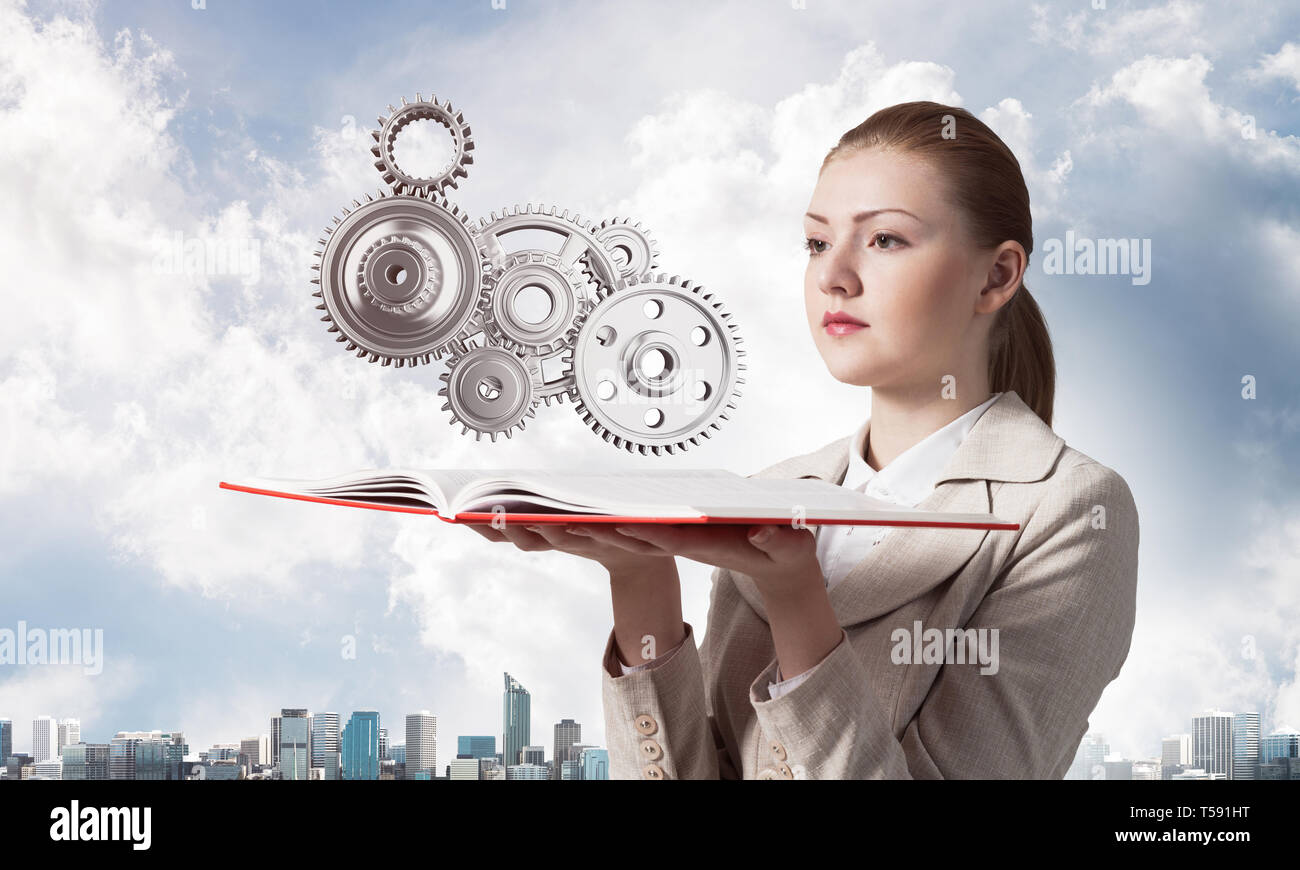 Woman holding open notebook with mechanism Stock Photo - Alamy