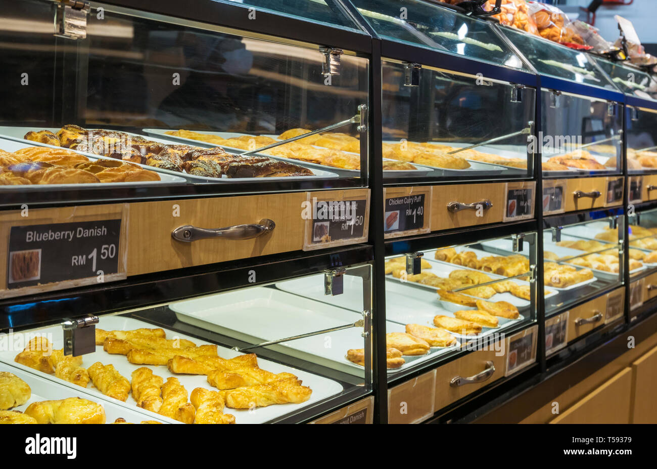 Assorted pastry and bread arranged on tray at bakery shop Stock Photo - Alamy