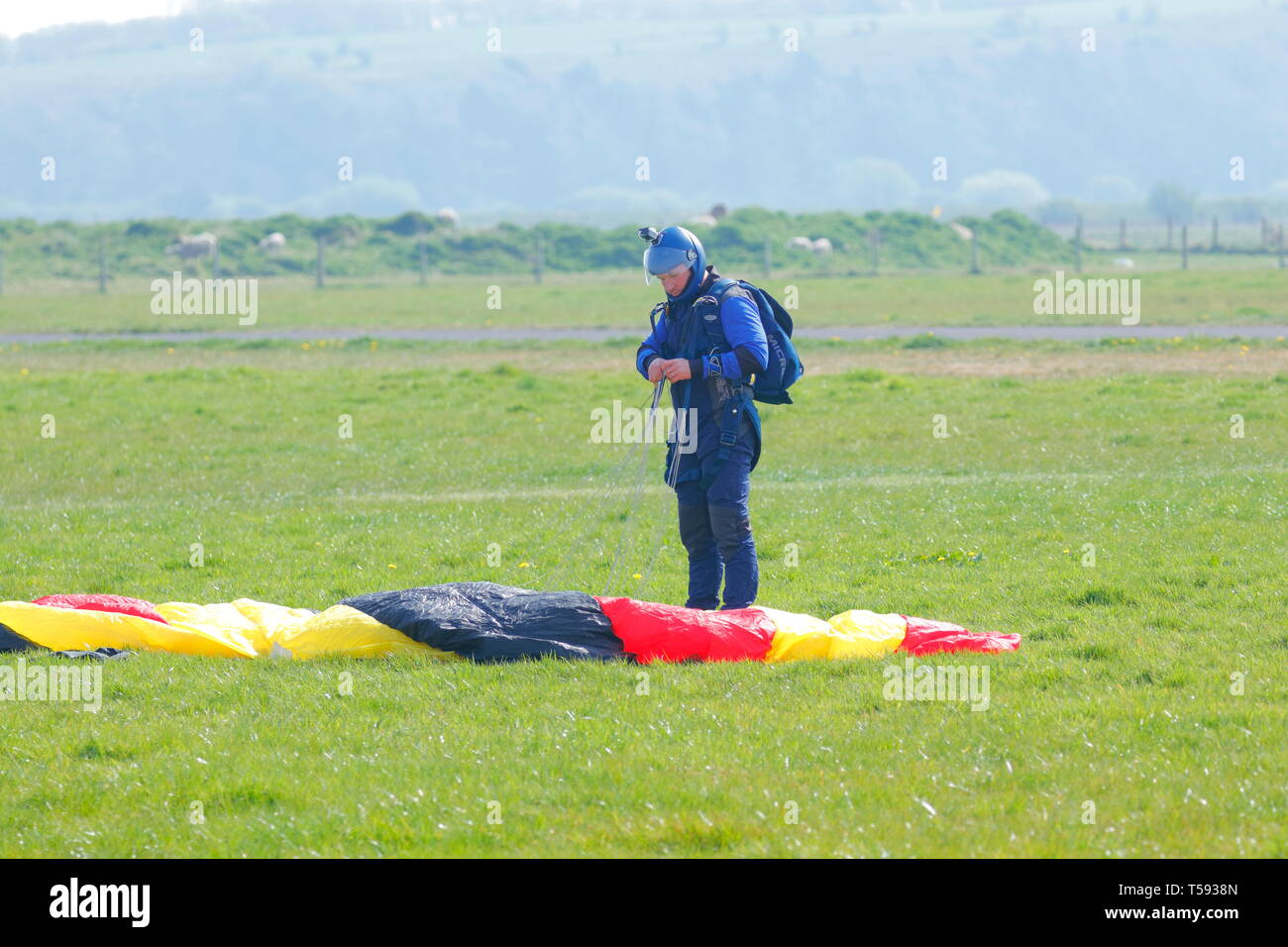 A skydiver on the ground, after completing a jump from an aircraft at ...
