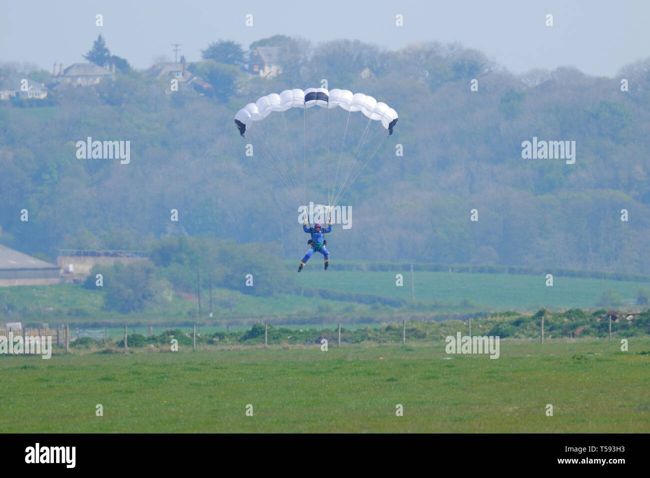 A skydiver freefalls in a parachute after jumping 1000s of feet from an ...