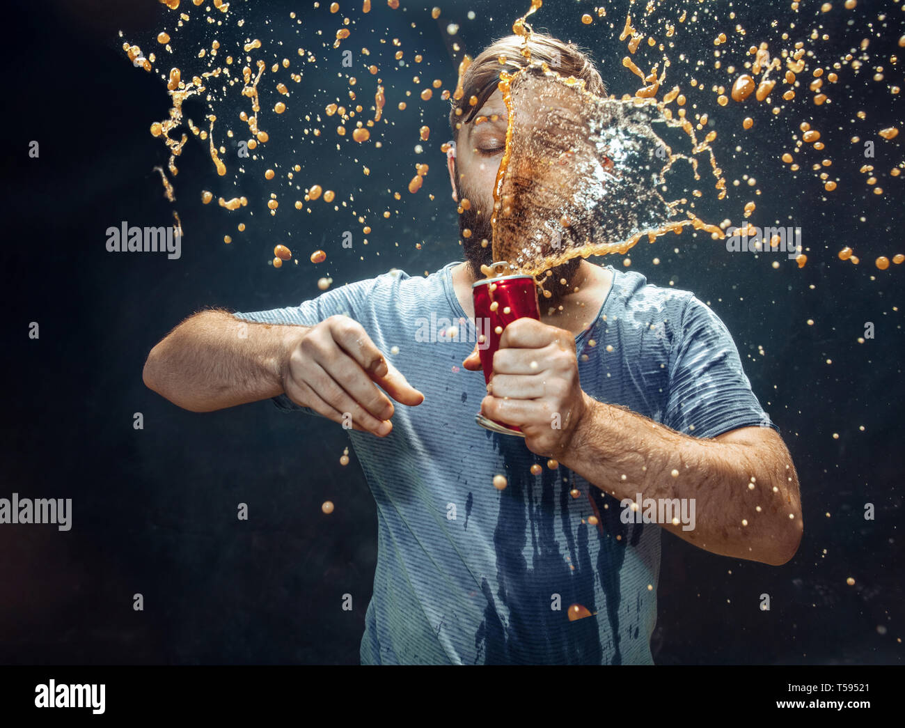 Man drinking a cola at studio. Young smiling happy caucasian guy ...