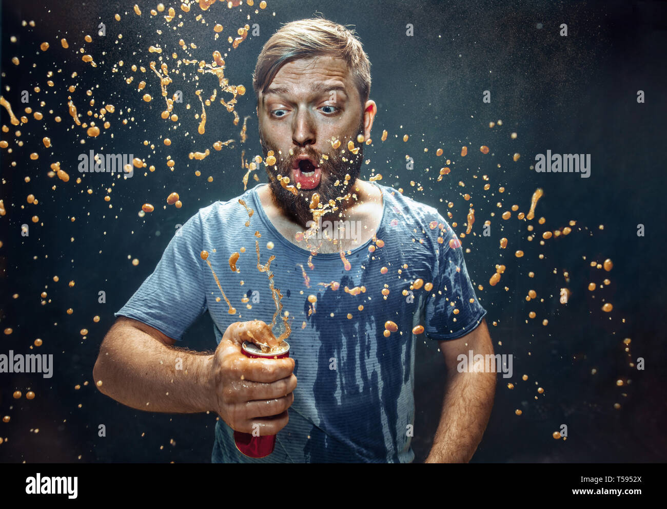 Man drinking a cola at studio. Young smiling happy caucasian guy ...