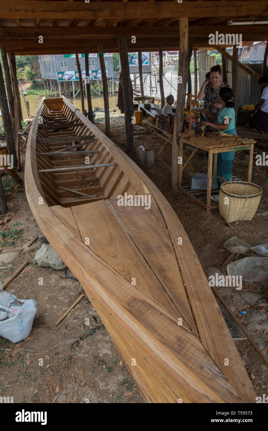 Traditional wooden boat being constructed in a workshop by Inle Lake ...