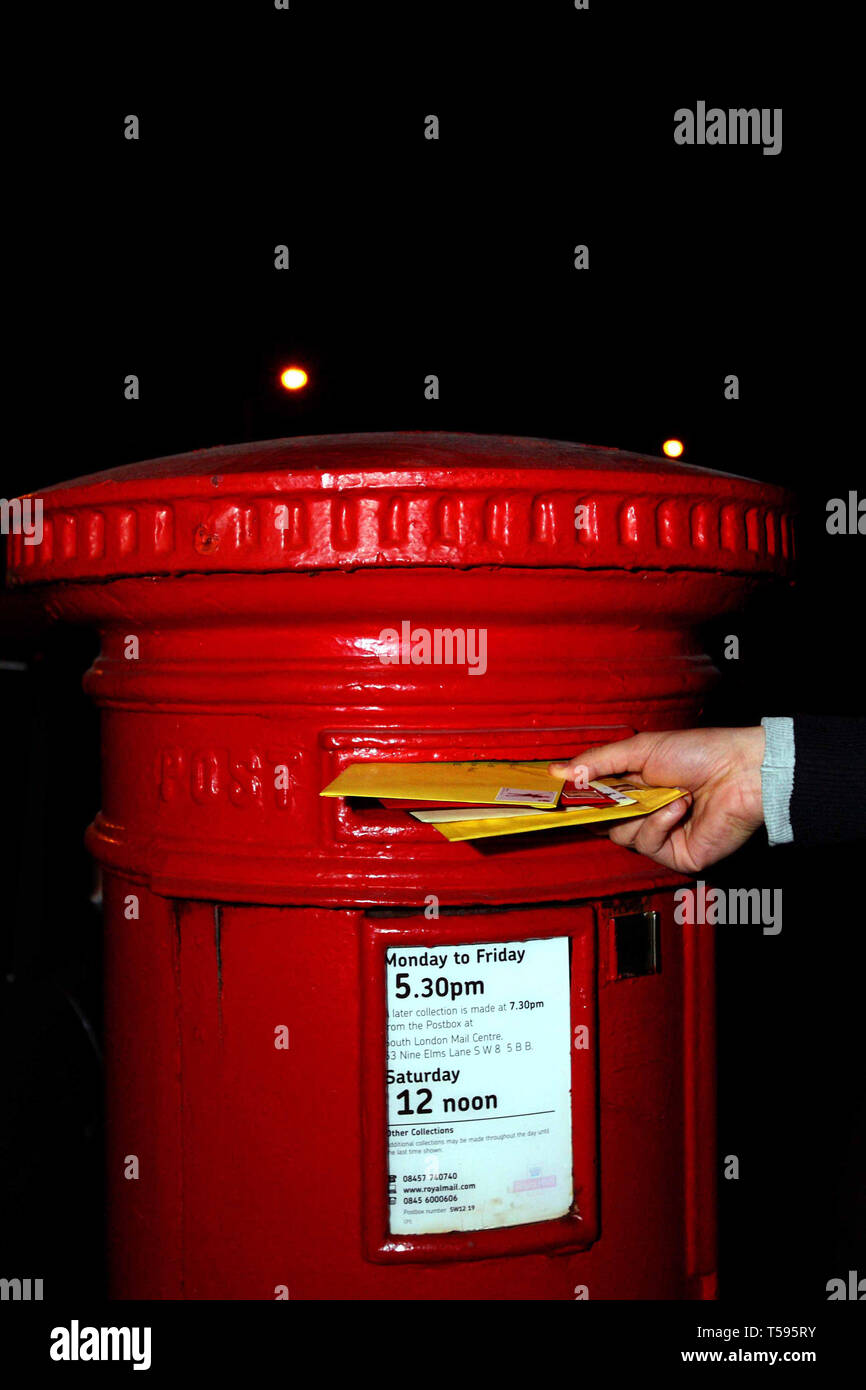Posting a letter in a postbox at night. London. 20.10.2009 Stock Photo ...