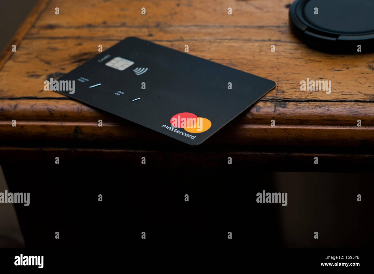 Plain black electronic card on table with lens cap Stock Photo - Alamy