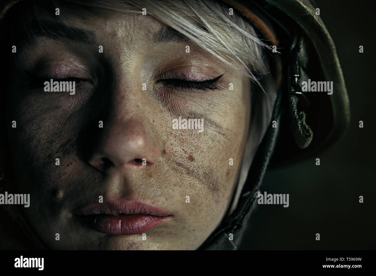 No tears and no fear anymore. Close up portrait of young female soldier ...