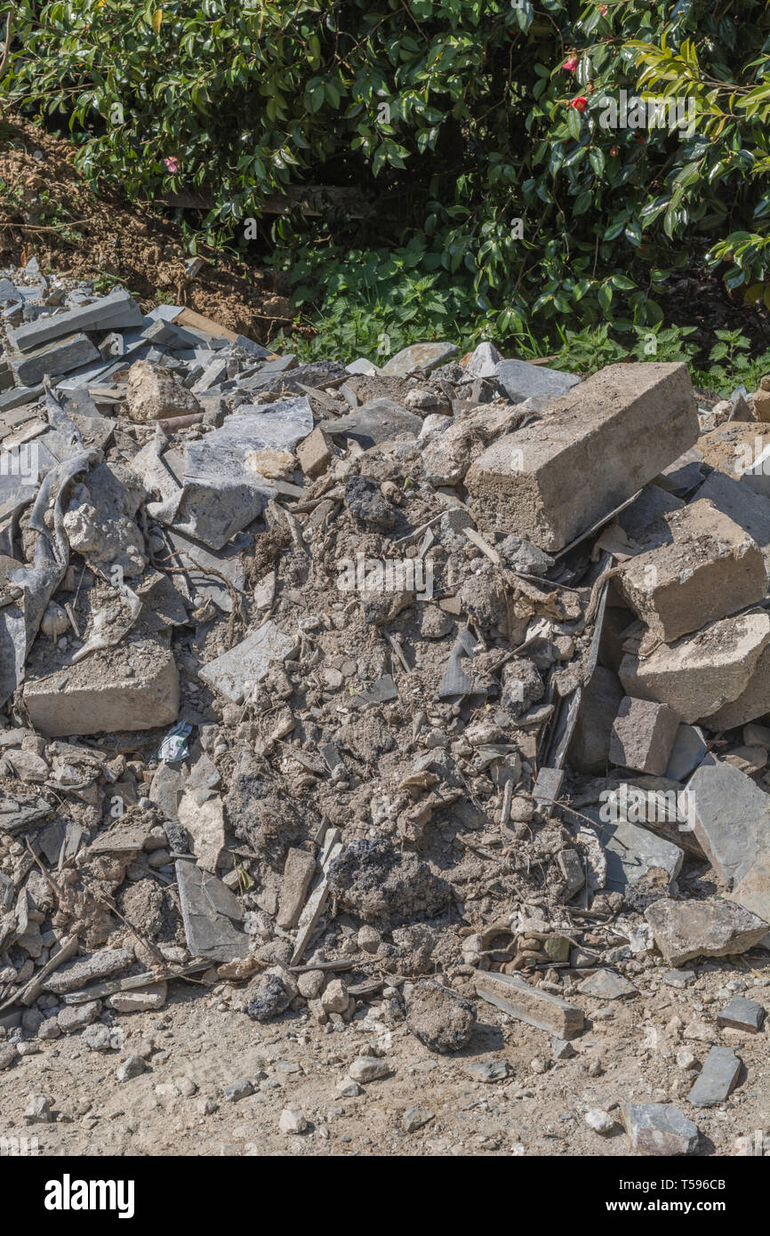 Pile of builder's rubble in sunshine. Metaphor fly tipping by roadside ...