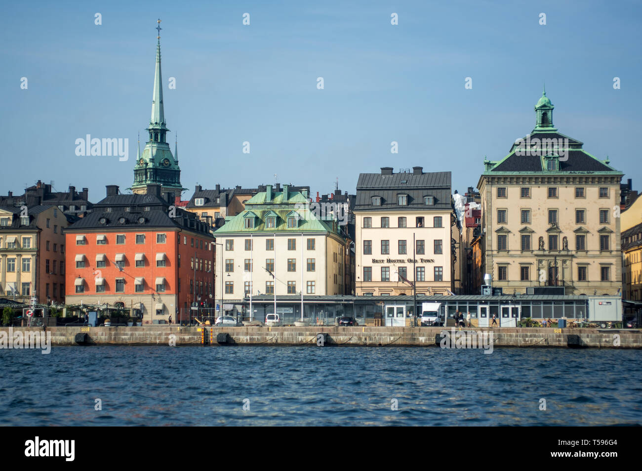 The spire of Tyska Kyrkan (the German Church) and colourful buildings ...