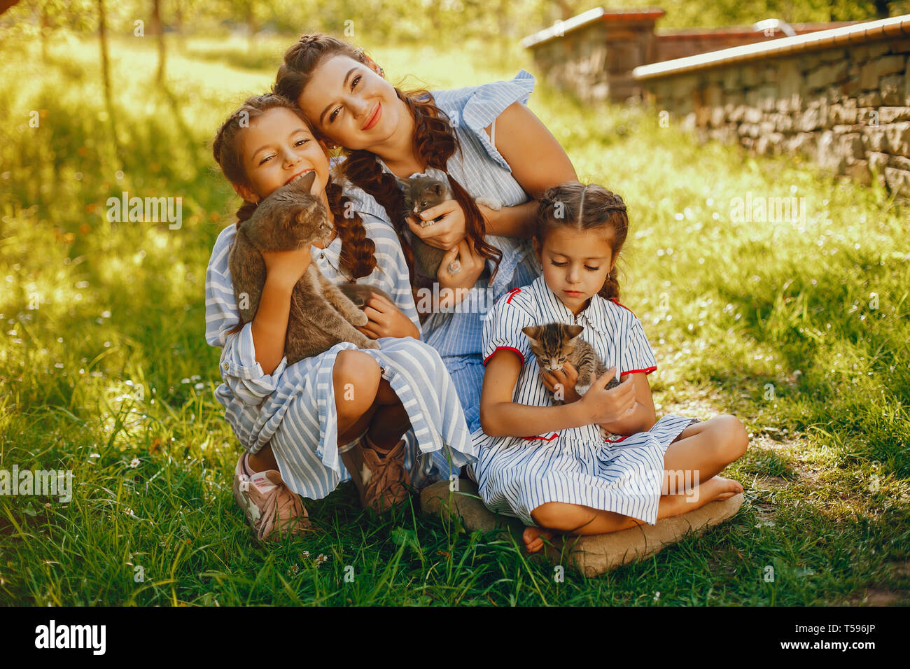 three beautiful girls with cats Stock Photo - Alamy