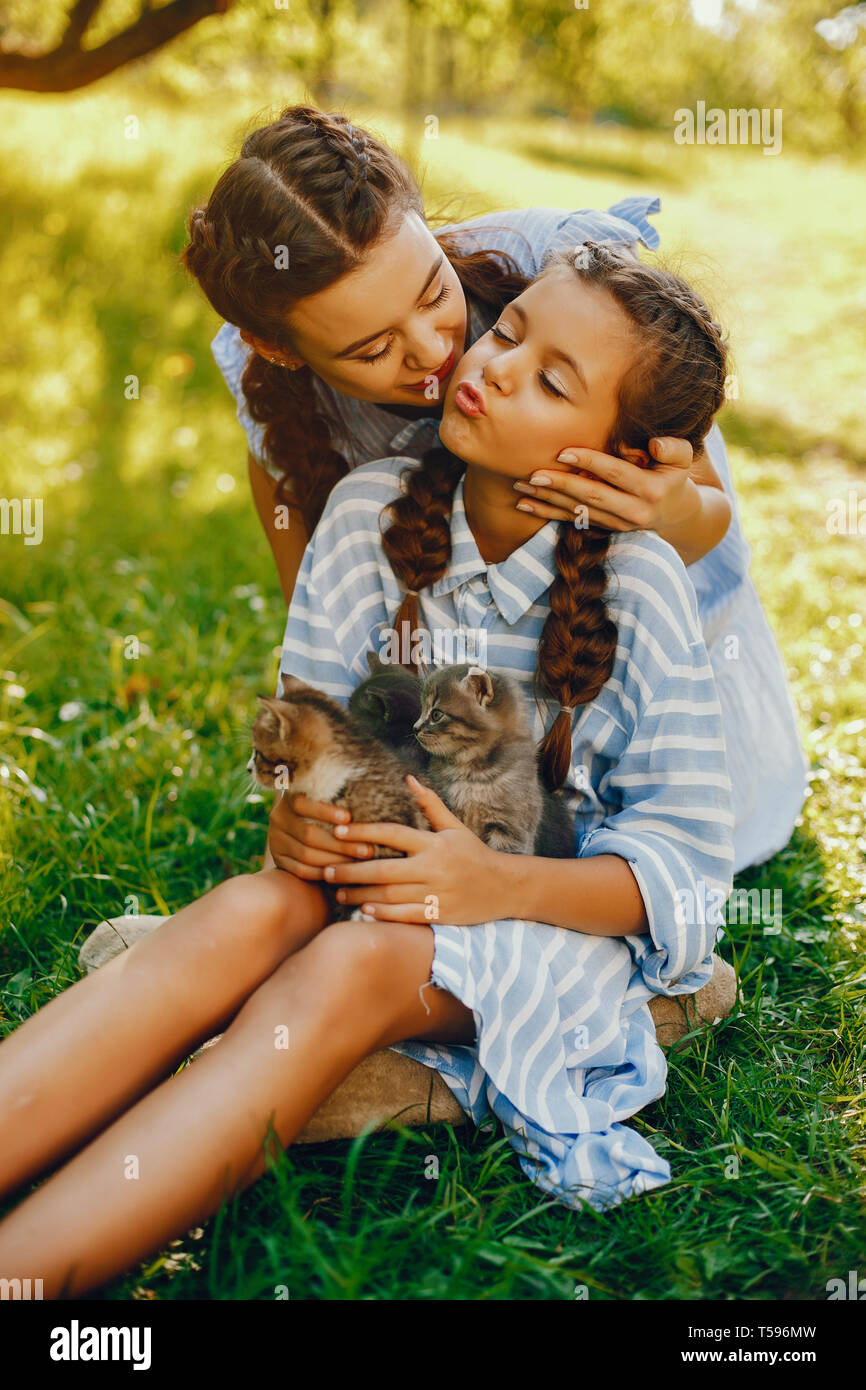 two beautiful girls with cats Stock Photo - Alamy