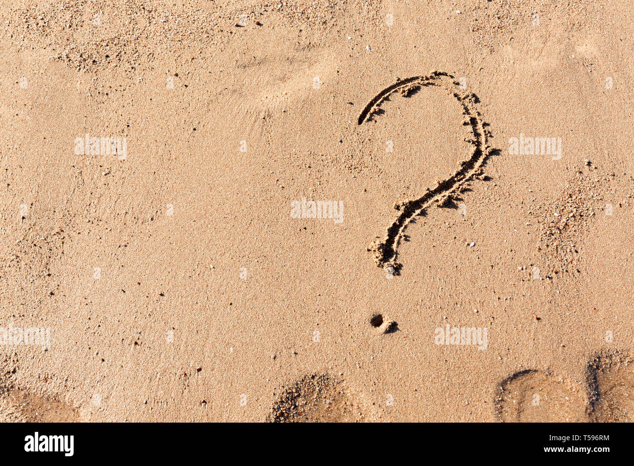 Question mark sign on sand beach near the sea. Concept of dilemma ...