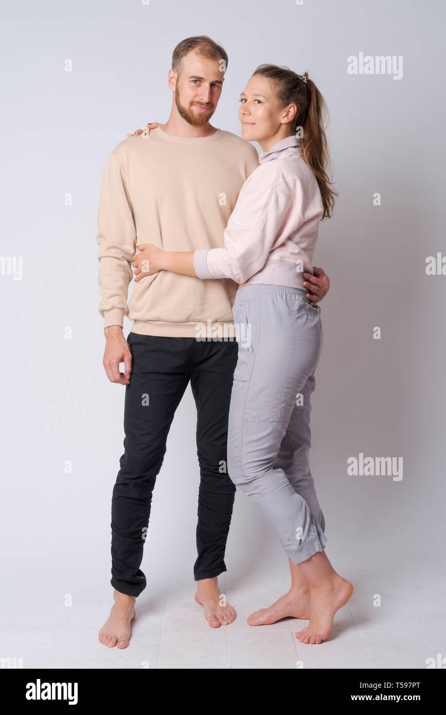 Full body shot of young couple hugging together Stock Photo - Alamy