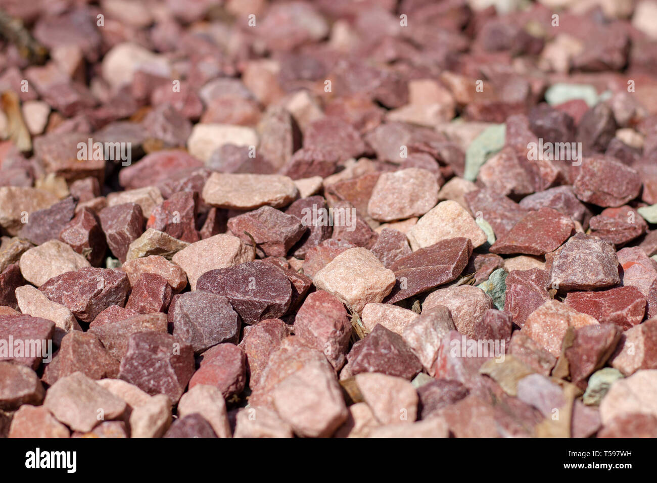 Making flower beds multicolored rubble. Crushed stone of red color on a ...