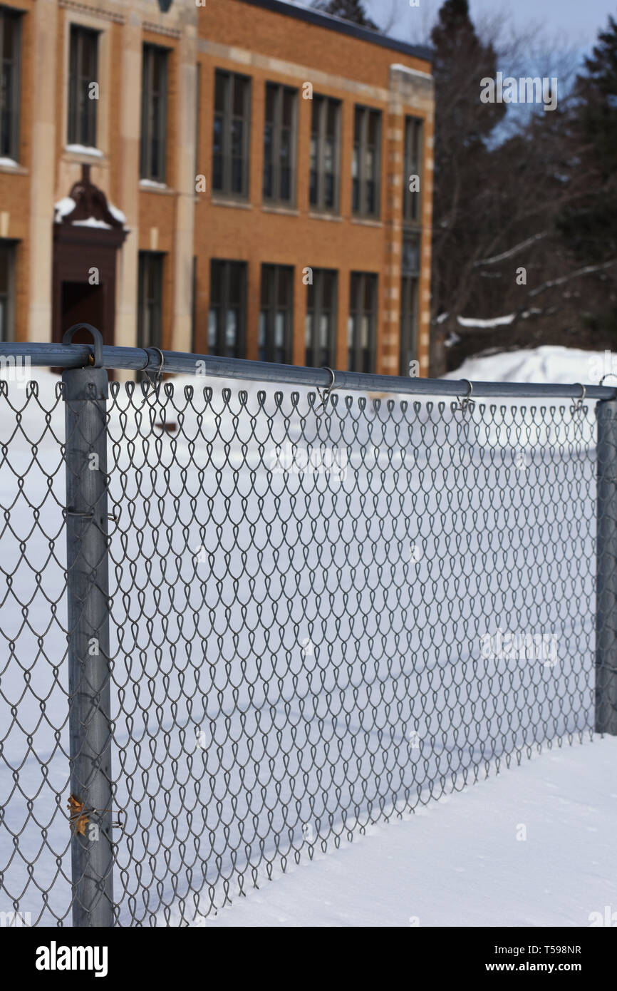 Chain link fence in front of building Stock Photo - Alamy