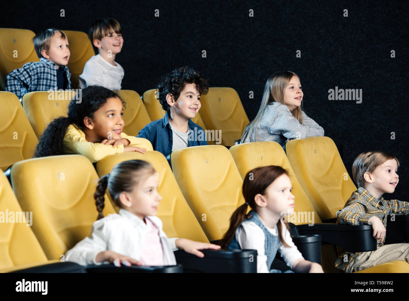smiling multicultural friends watching movie in cinema together Stock ...