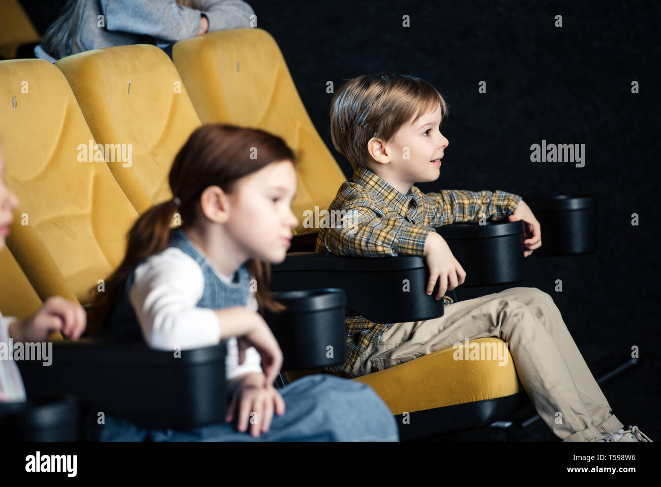 selective focus of two friends watching movie in cinema together Stock ...