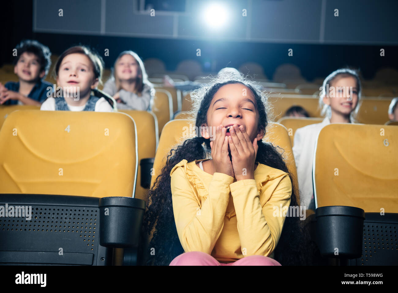 cheerful multicultural friends watching movie in cinema together Stock ...