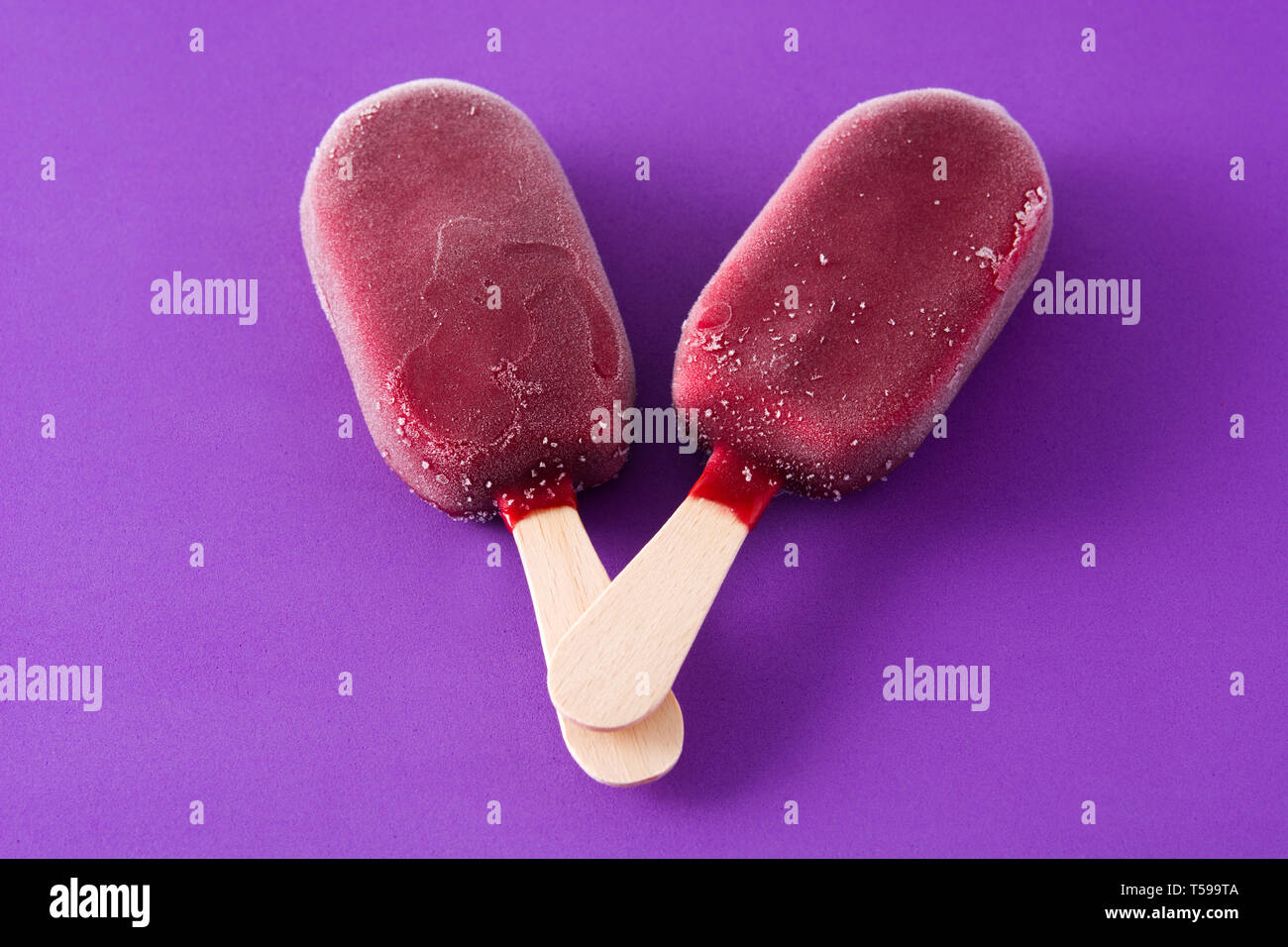 Strawberry popsicle on violet background Stock Photo - Alamy