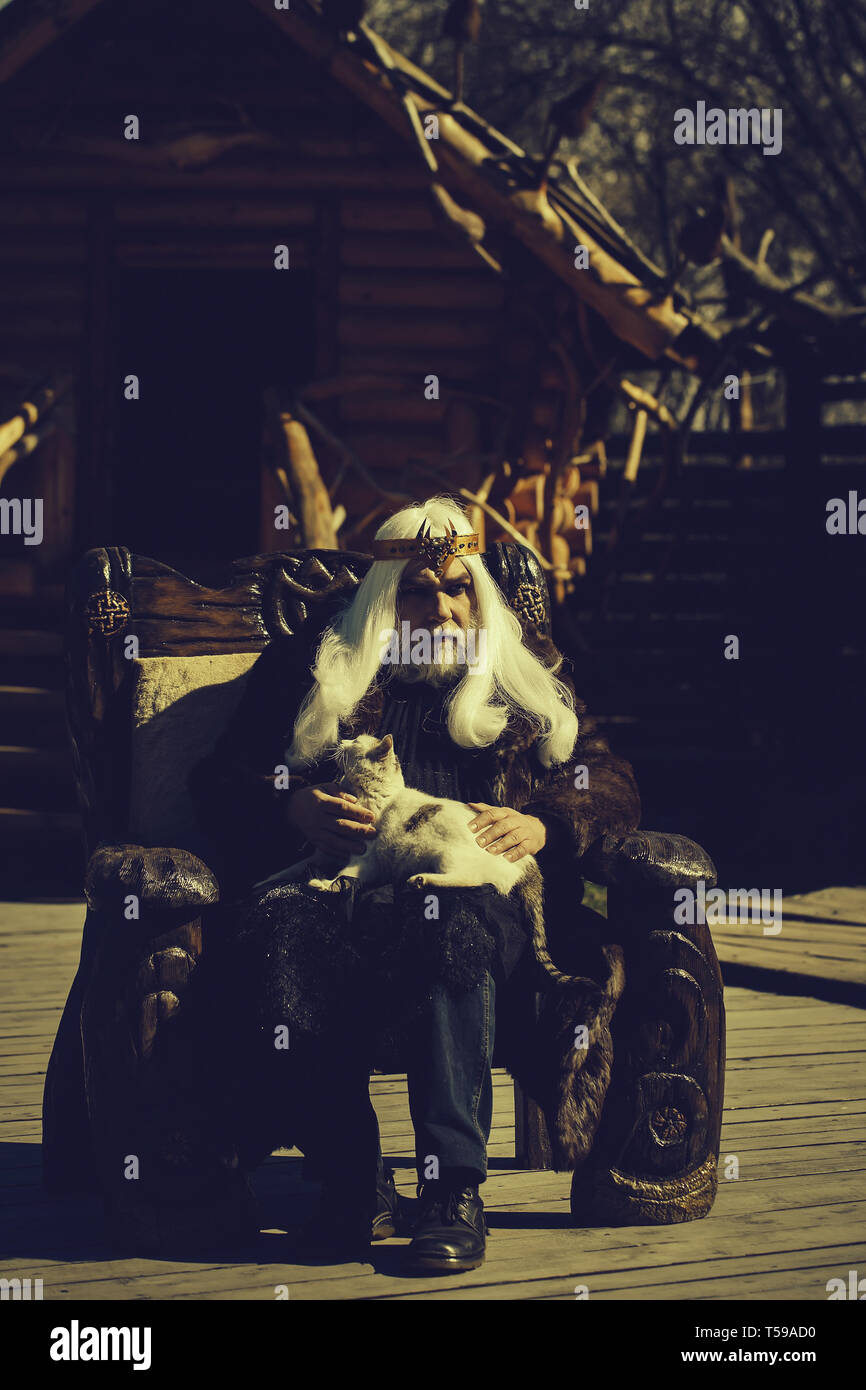 Old druid sits in chair Stock Photo - Alamy