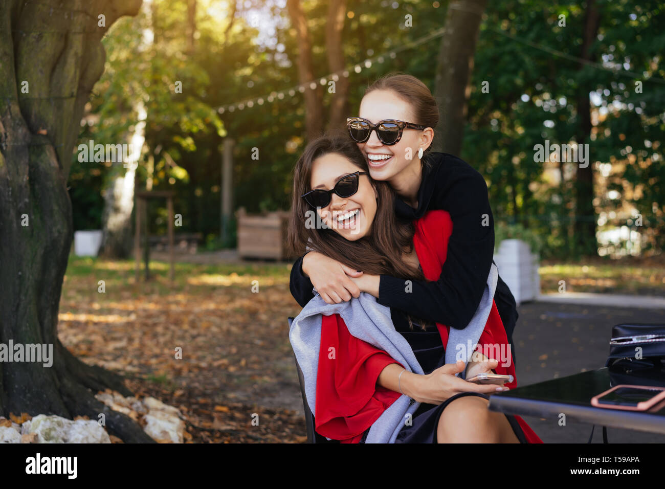 Girl hugging her friend. Portrait Two girlfriends in the park Stock ...