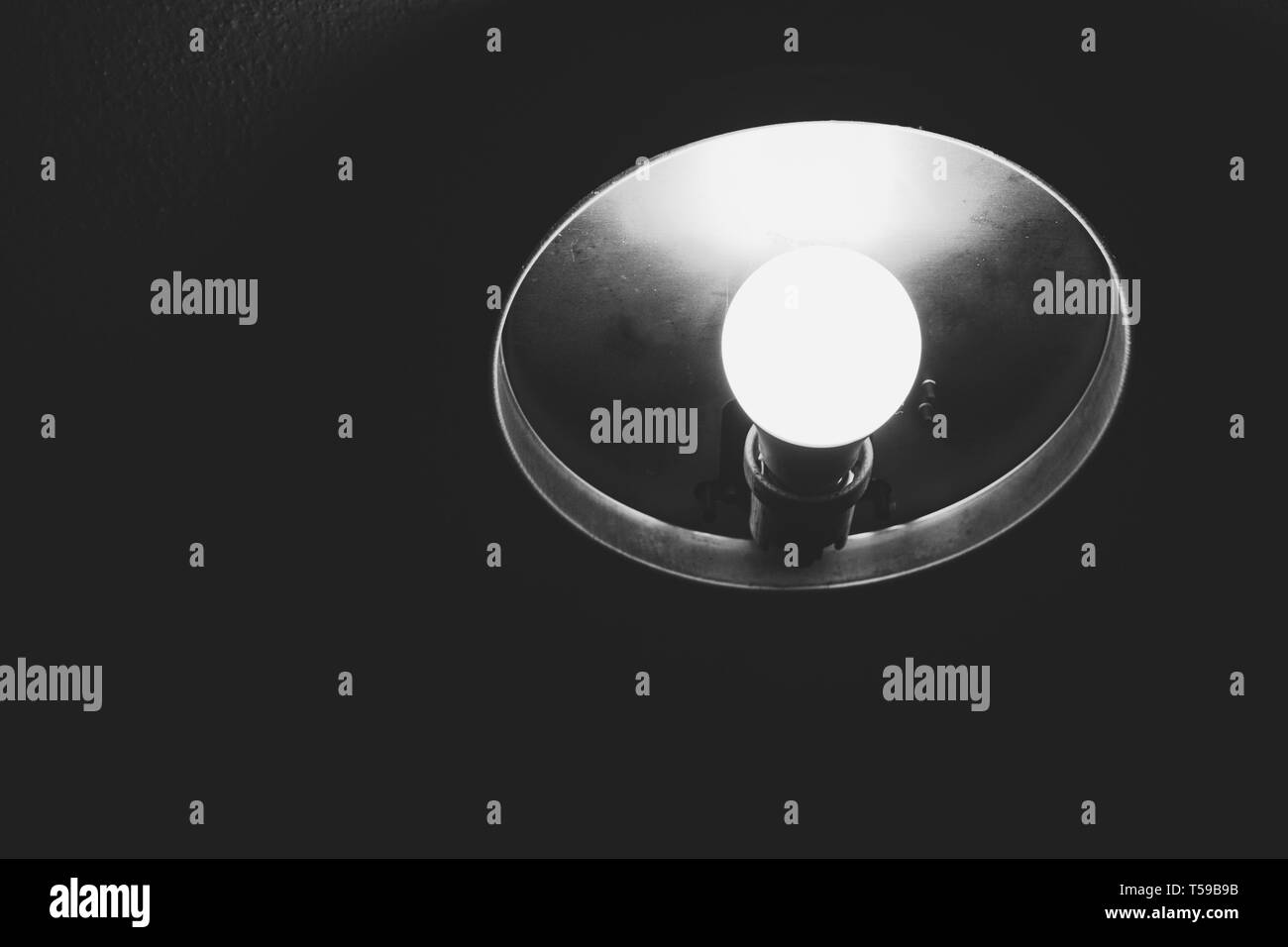 isolated underexposed old bulb light in black and white Stock Photo - Alamy