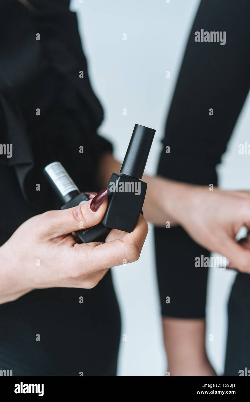 Woman holds black mascara in her hand Stock Photo - Alamy