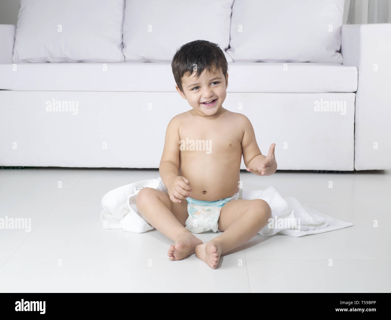 PORTRAIT OF INFANT IN DIAPER WITH HEAD COVERED BY A TOWEL Stock Photo ...