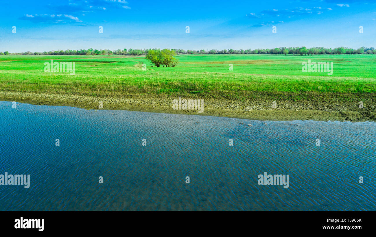 Spring landscape with the river and the sun Stock Photo - Alamy